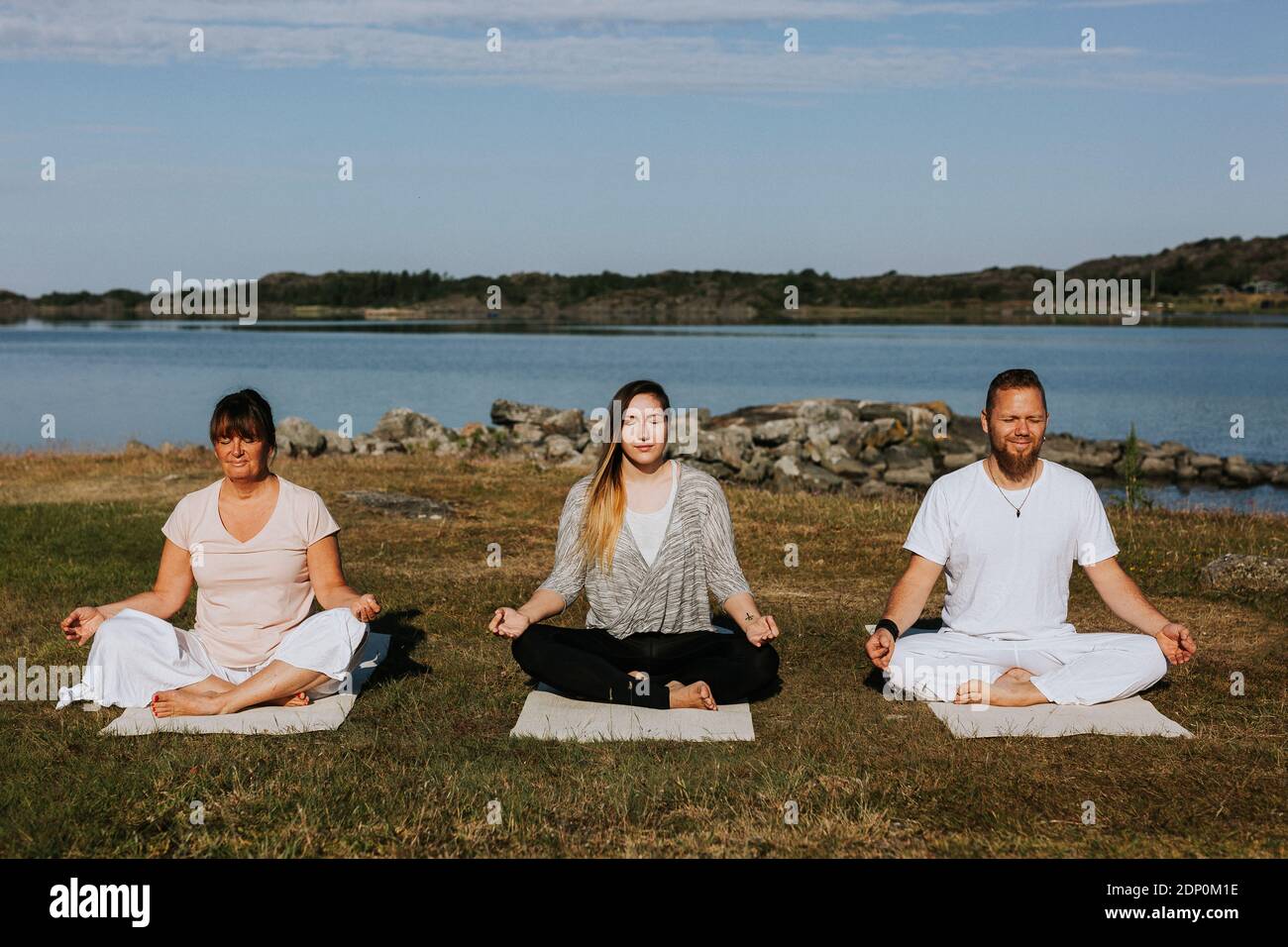 People meditating at sea Stock Photo - Alamy