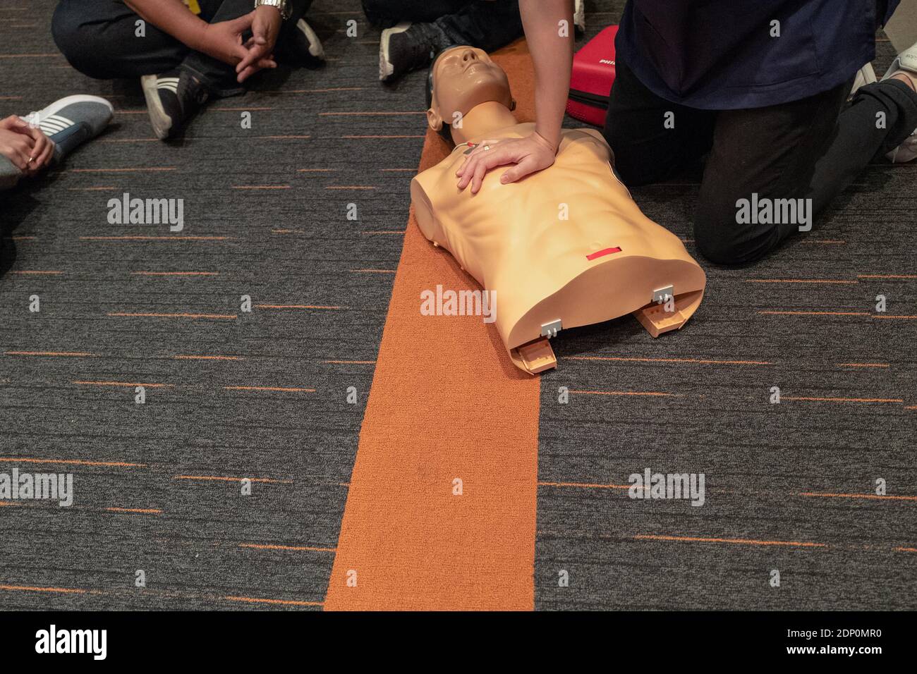 Low Section Of Man Showing Cpr Over Dummy By People On Floor Stock ...