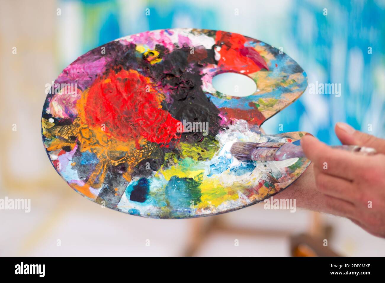 Artist holding colorful color palette. Painting therapy Stock Photo - Alamy