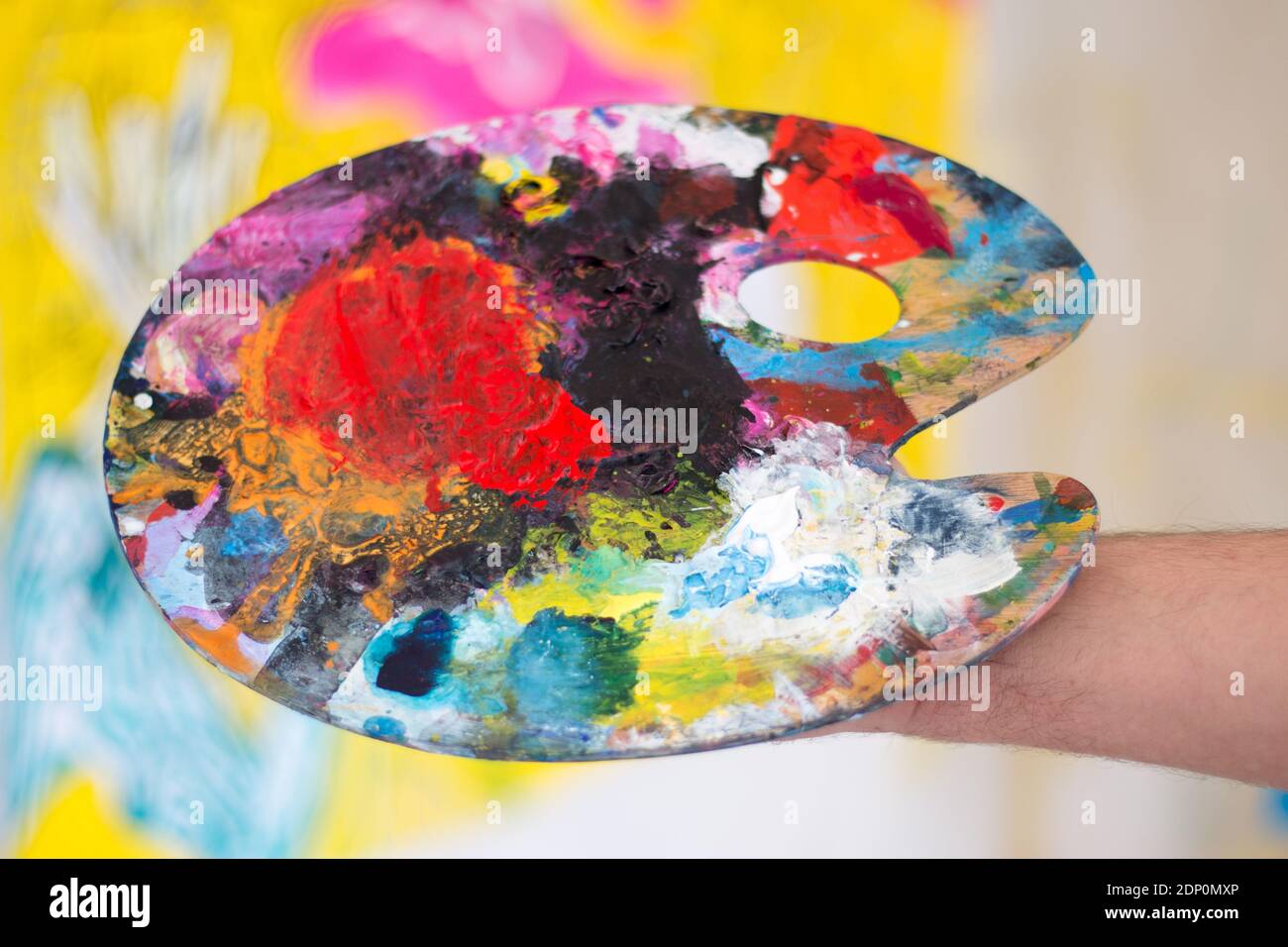 Artist holding colorful color palette. Painting therapy Stock Photo - Alamy