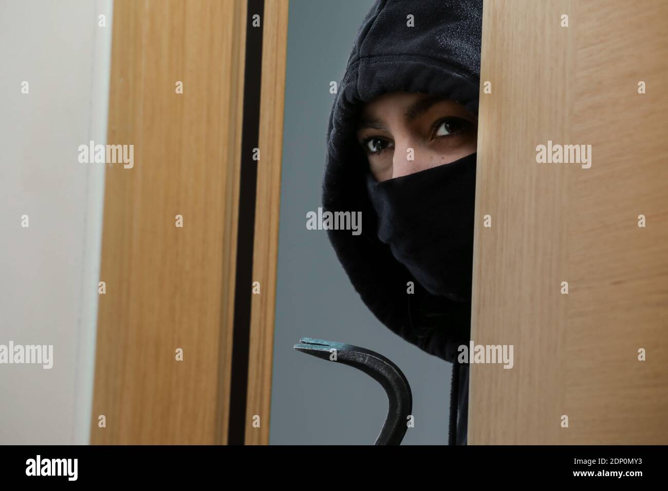 Thief broke into the apartment. House robbery by woman in a black ...