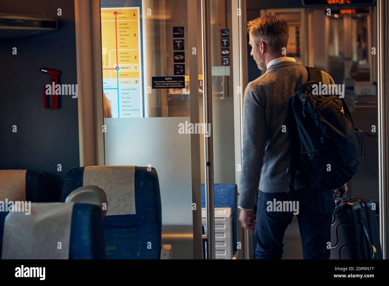 Man standing in train Stock Photo - Alamy