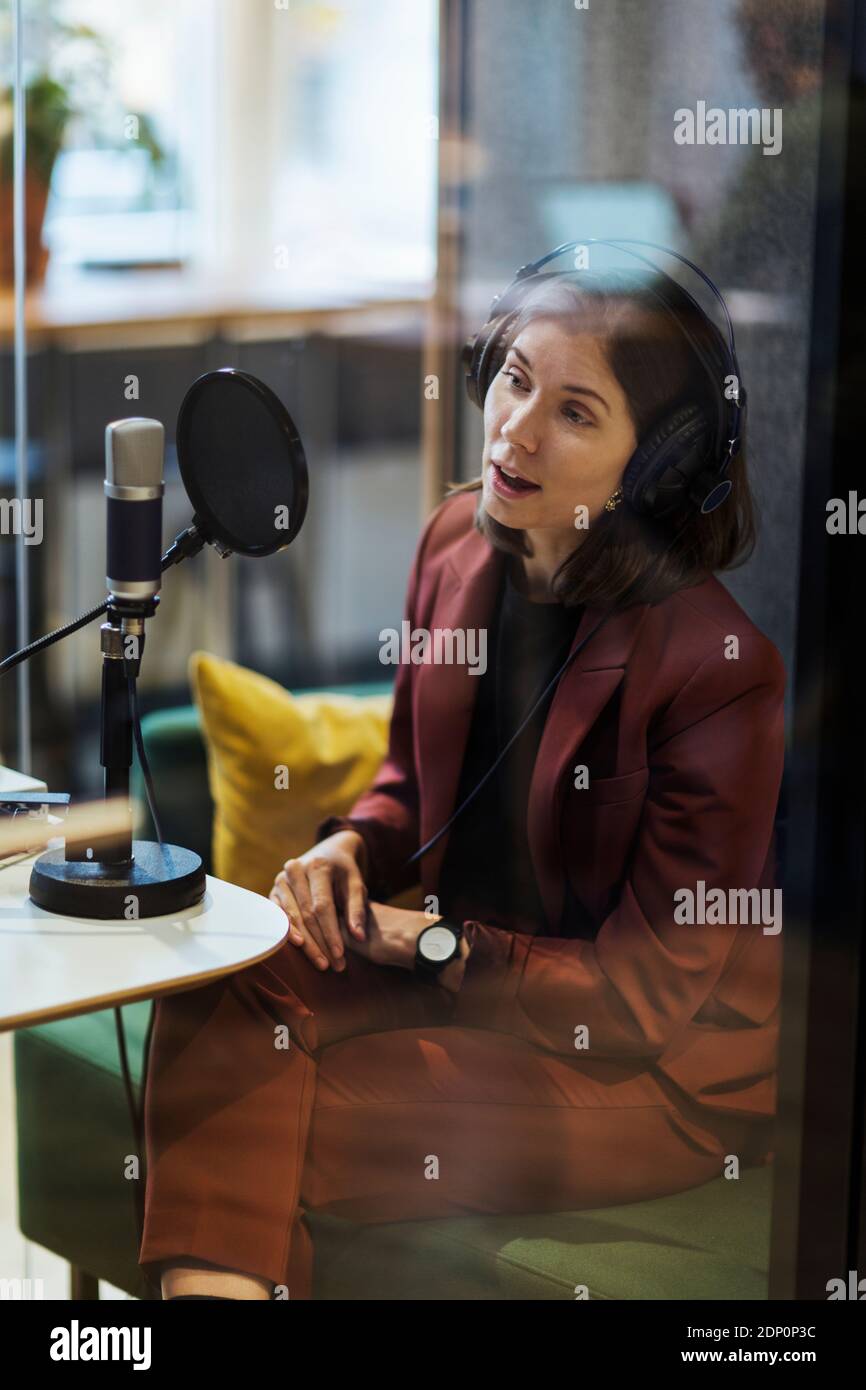 Woman broadcasting from radio station Stock Photo - Alamy