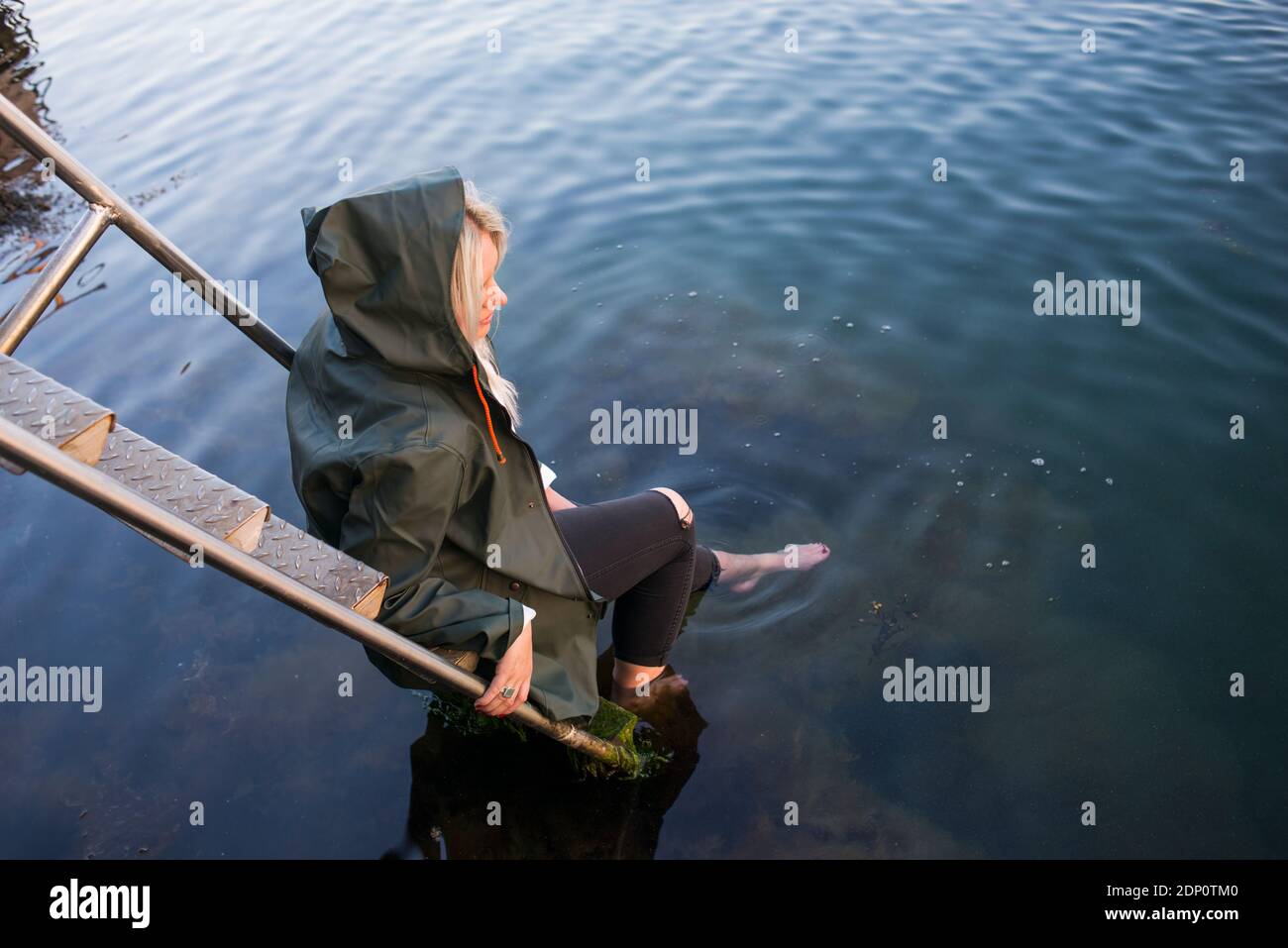 Woman with feet in sea Stock Photo - Alamy
