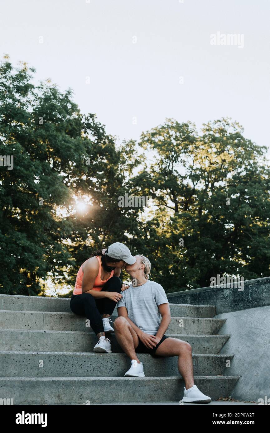 Couple on steps kissing Stock Photo - Alamy