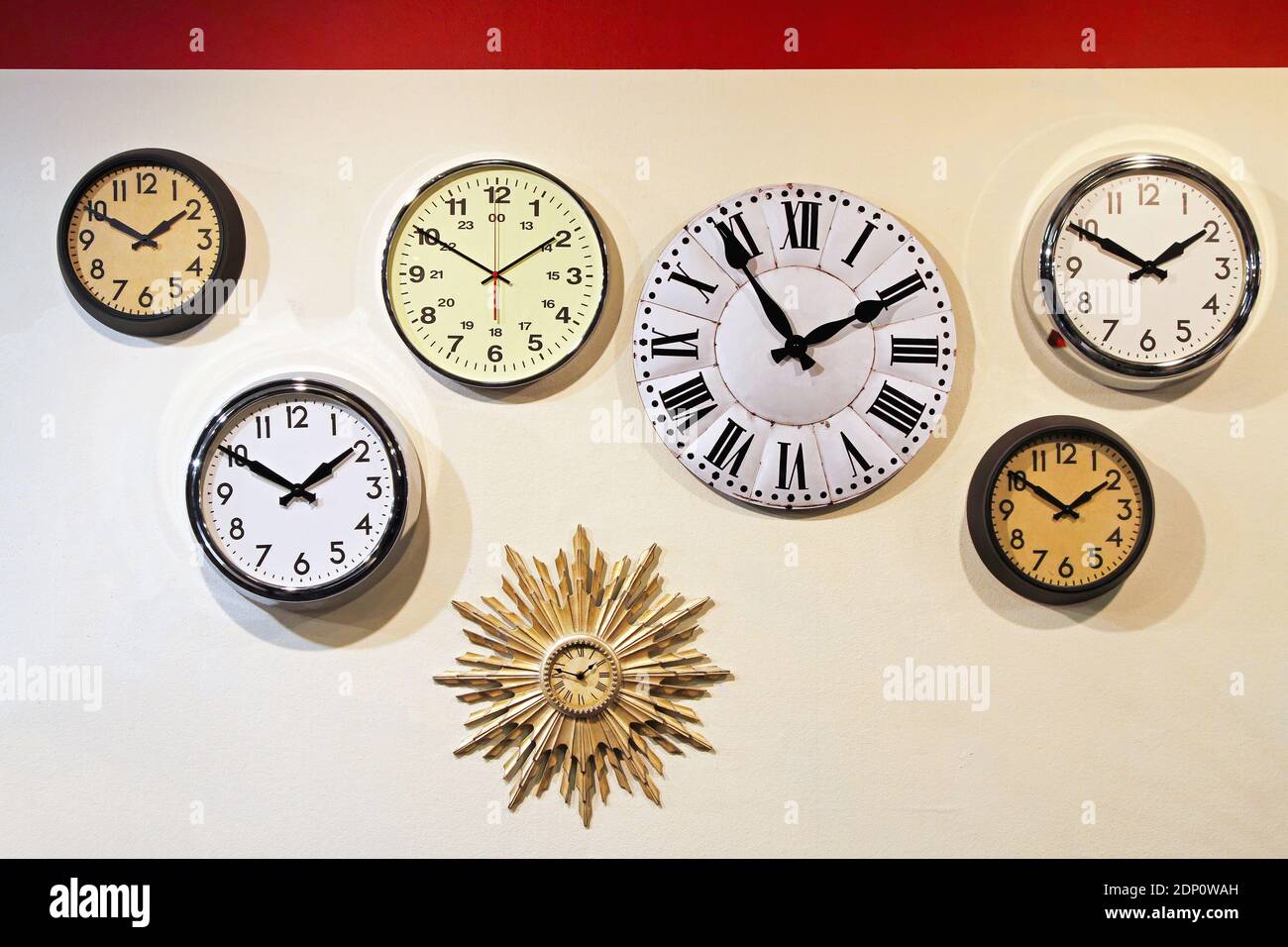 Seven different styles analog clocks on wall Stock Photo - Alamy