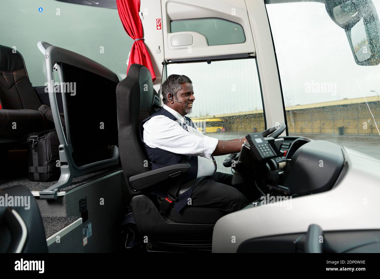 Driver driving bus Stock Photo - Alamy