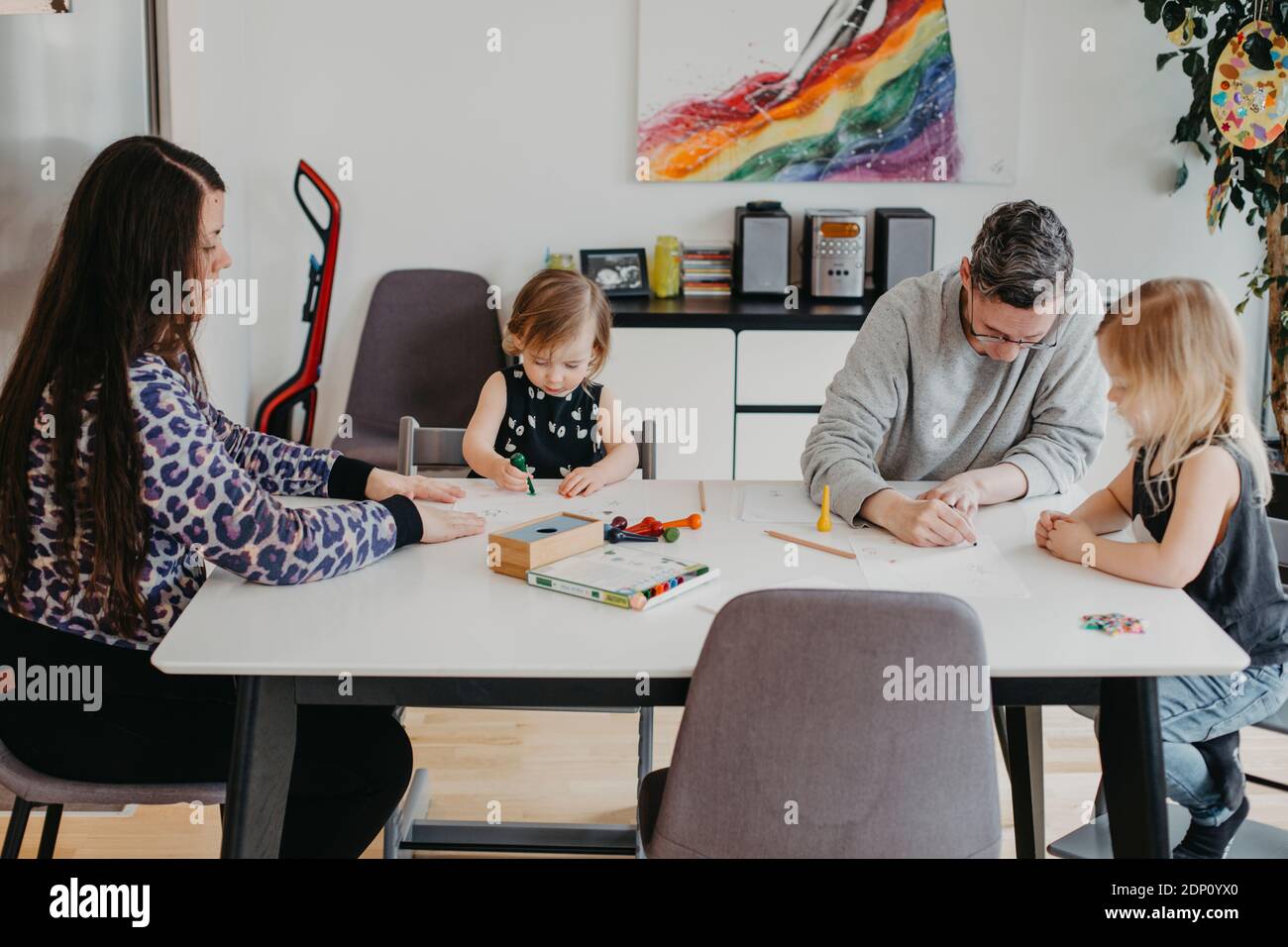 Parents with daughters drawing together Stock Photo - Alamy