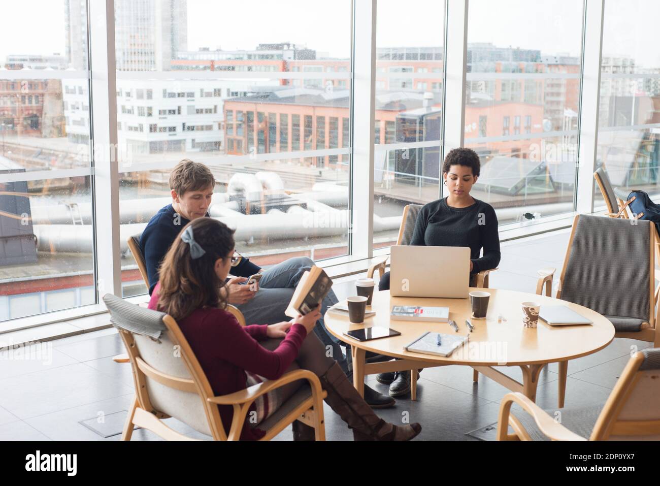 People sitting in library Stock Photo - Alamy