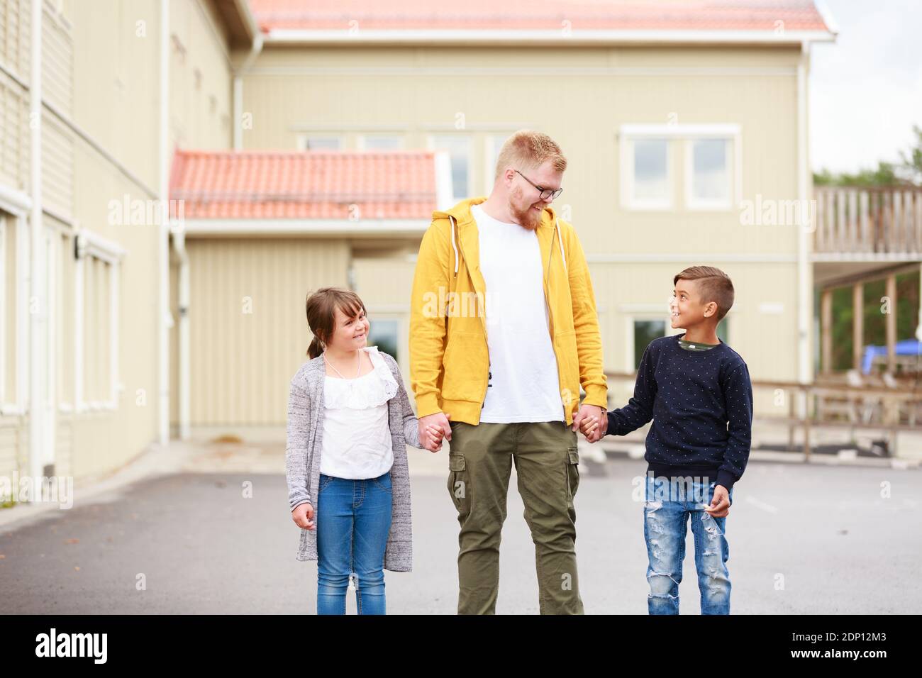 Father standing with children Stock Photo - Alamy