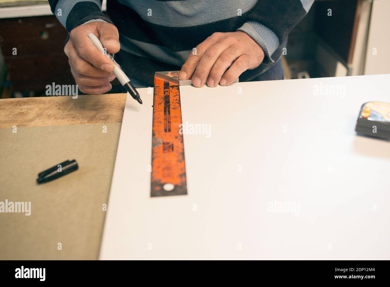 Carpenters hands measuring wood Stock Photo - Alamy