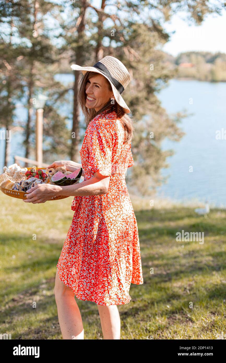 Happy woman carrying food on tray Stock Photo - Alamy