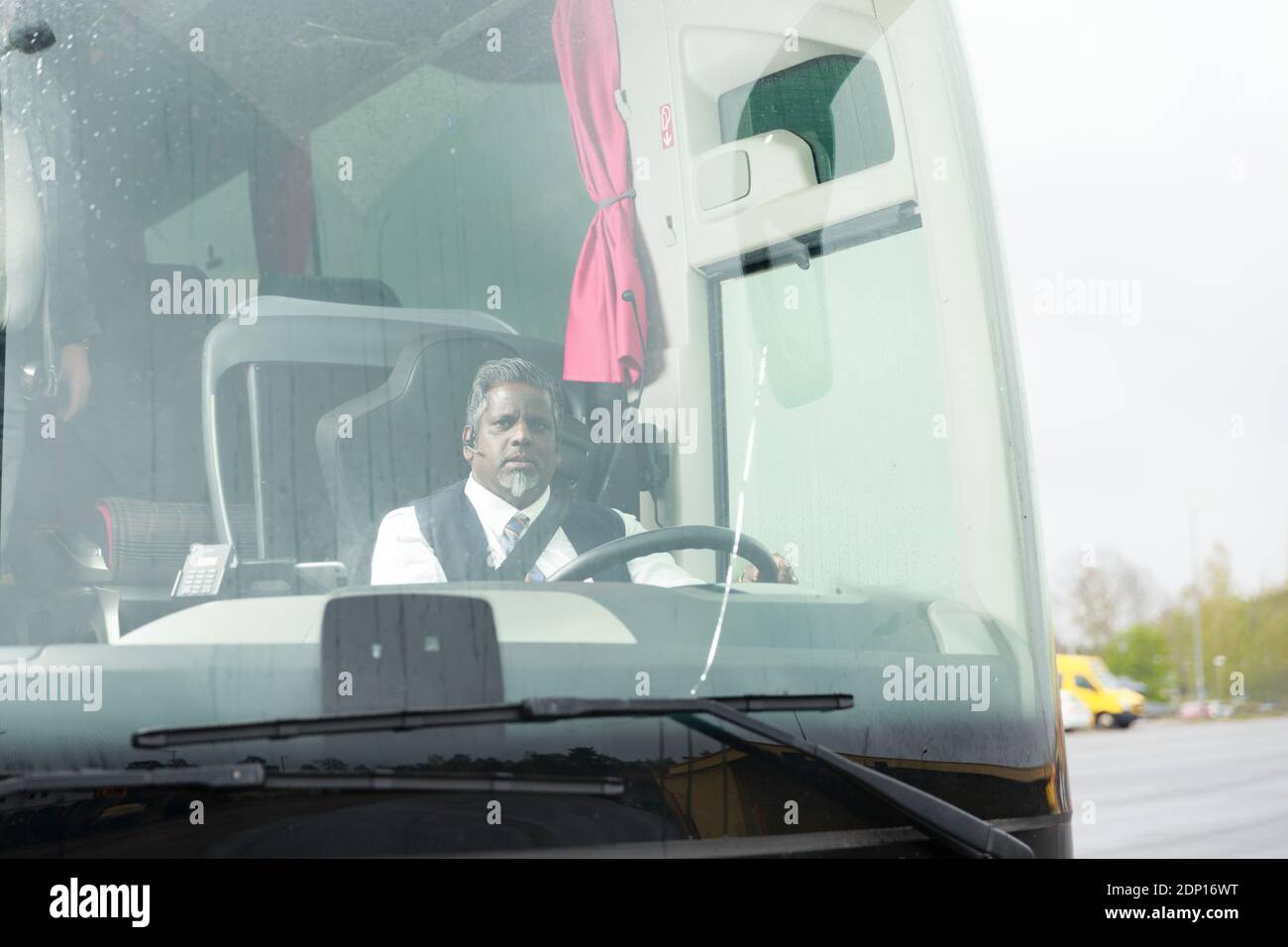Driver driving bus Stock Photo - Alamy