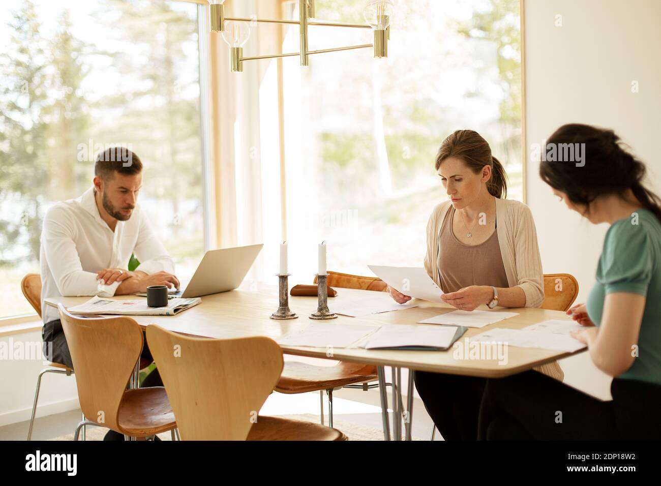 People working in living room Stock Photo - Alamy