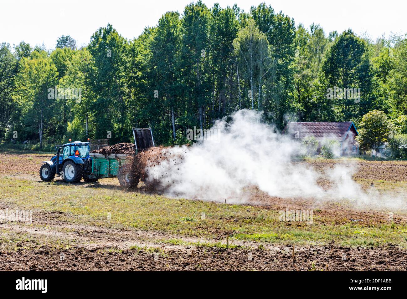 Tractor fertilizing field Stock Photo - Alamy