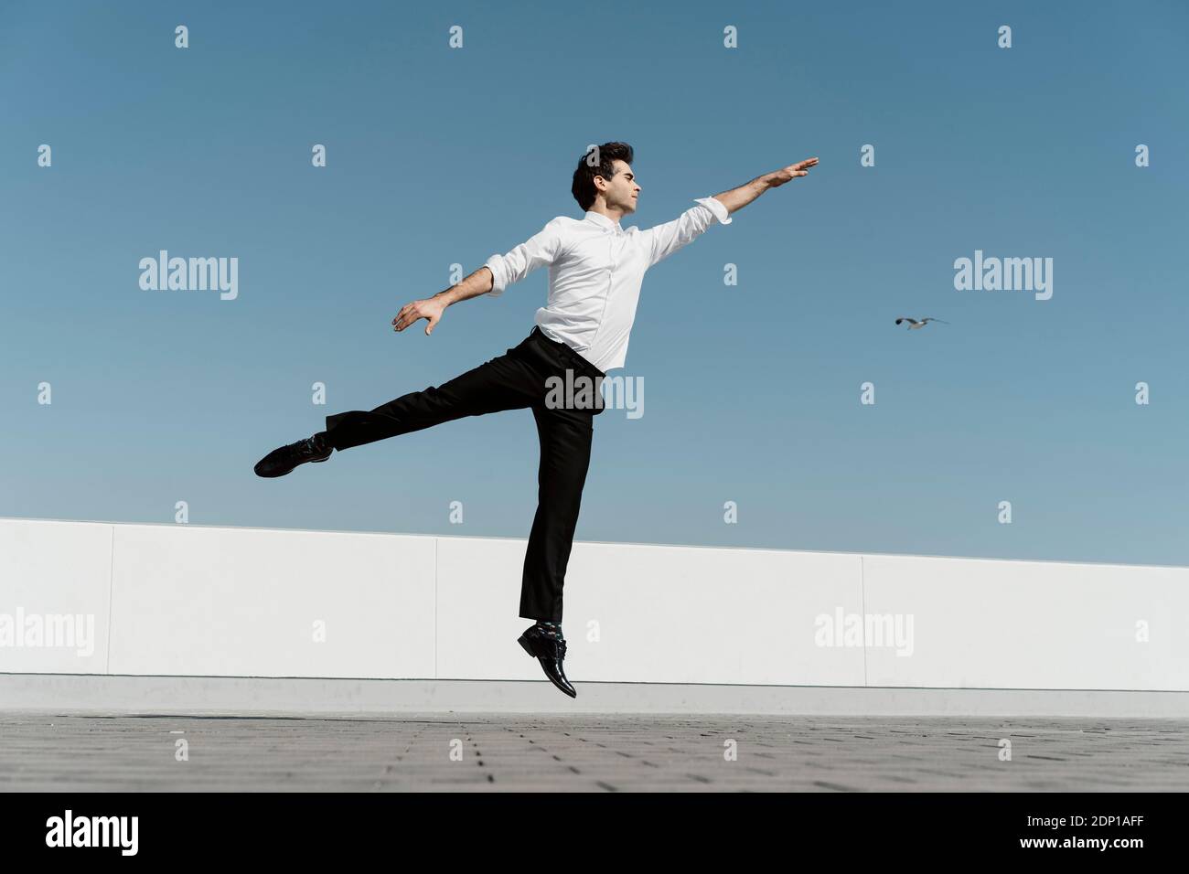 Artist practising on roof terrace Stock Photo - Alamy
