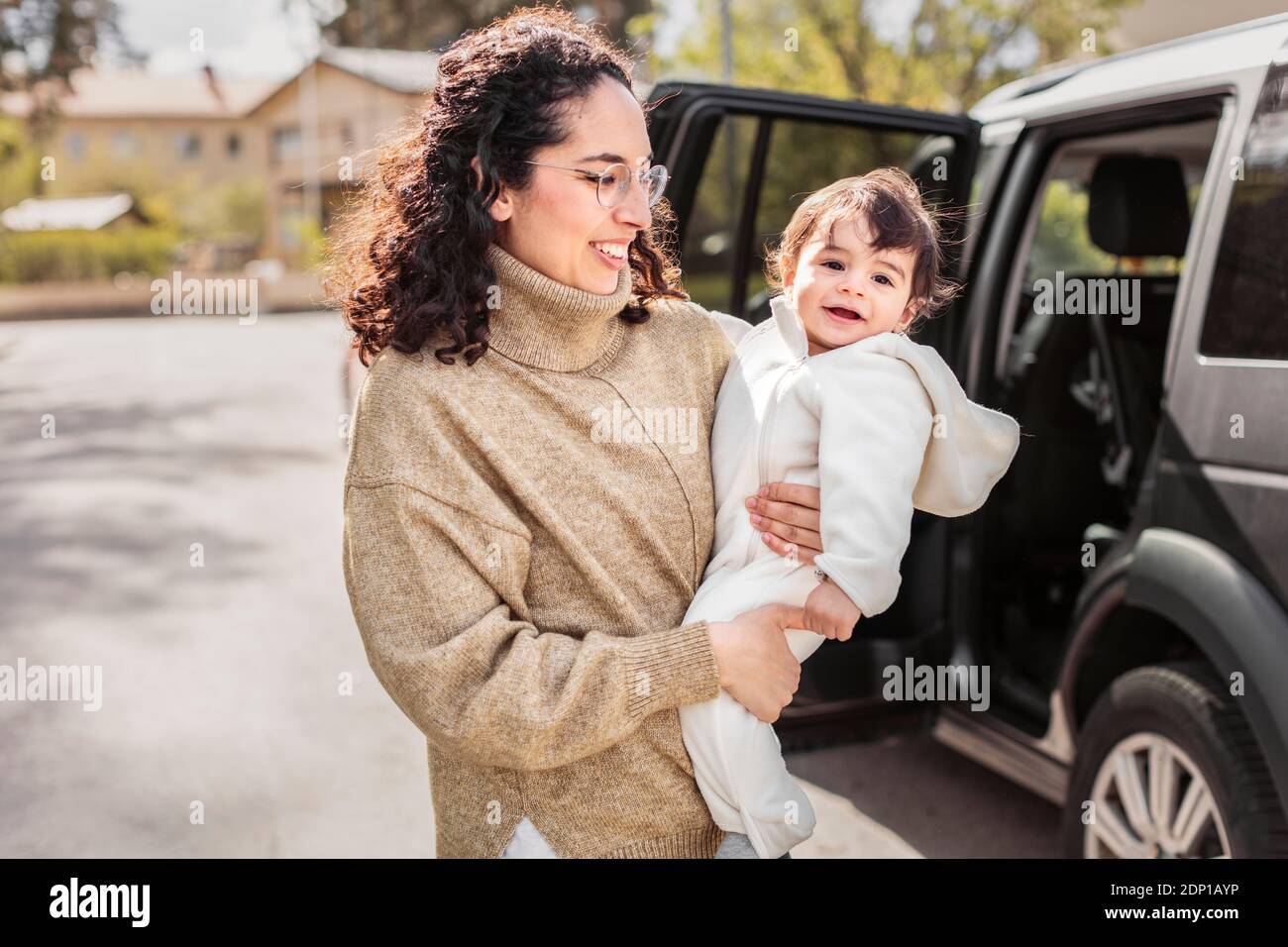 Woman carrying baby boy Stock Photo - Alamy