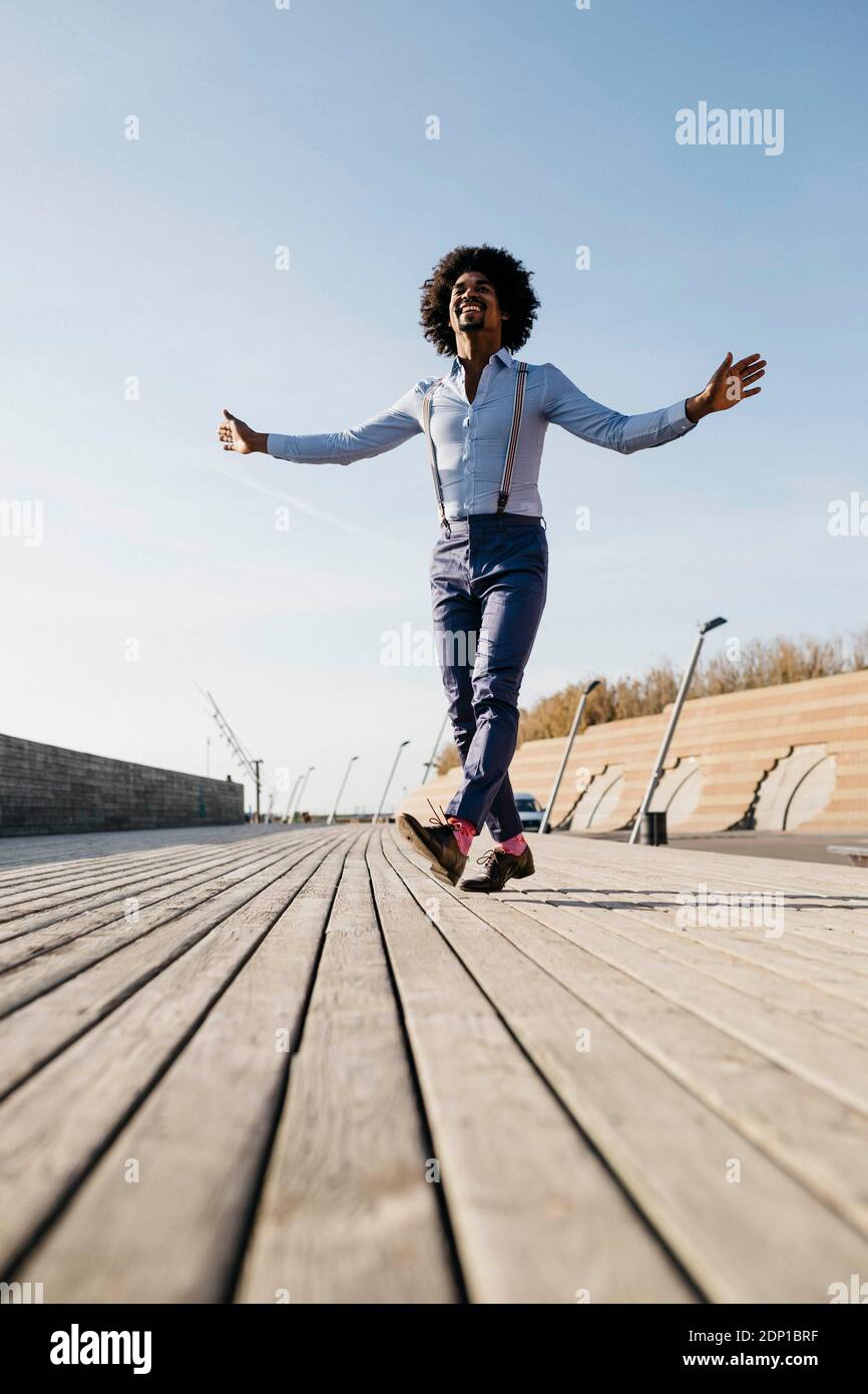 Happy man dancing on boardwalk Stock Photo - Alamy