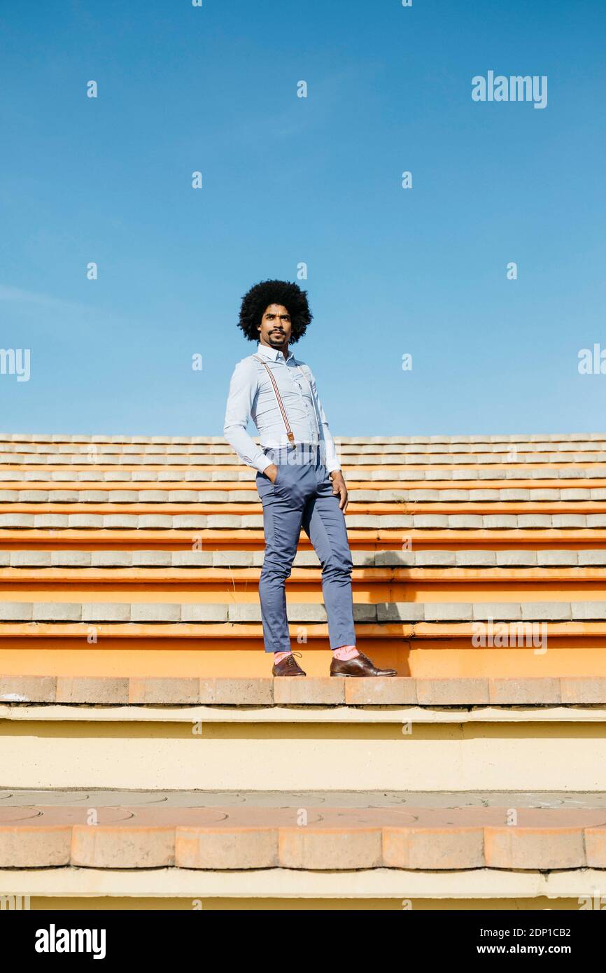 Stylish man standing on stairs Stock Photo - Alamy