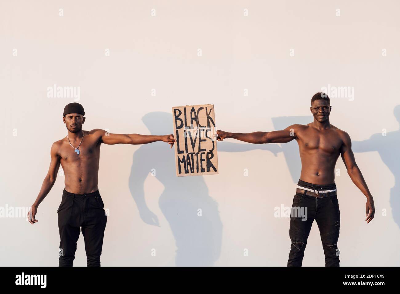 Two black men holding Black Lives Matter sign Stock Photo - Alamy
