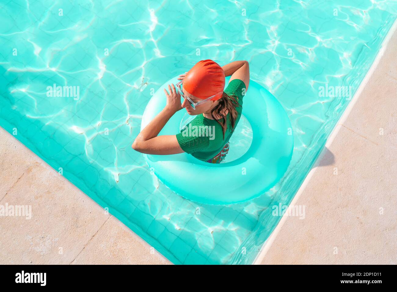 Woman with floating tire in swimming pool Stock Photo - Alamy
