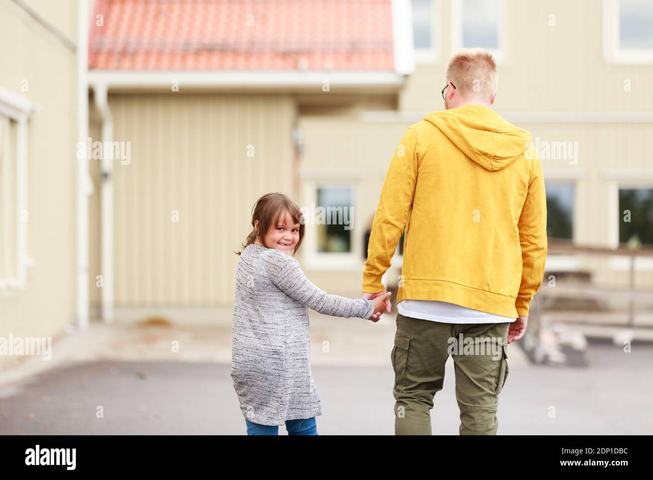 Father holding daughters hand Stock Photo - Alamy
