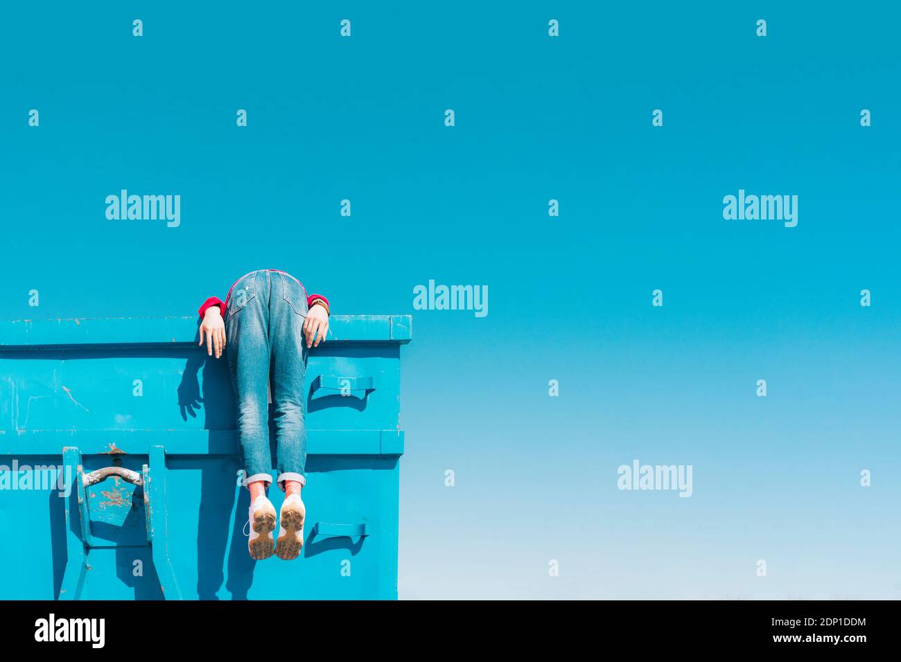 Young man hanging over edge blue container hi-res stock photography and ...