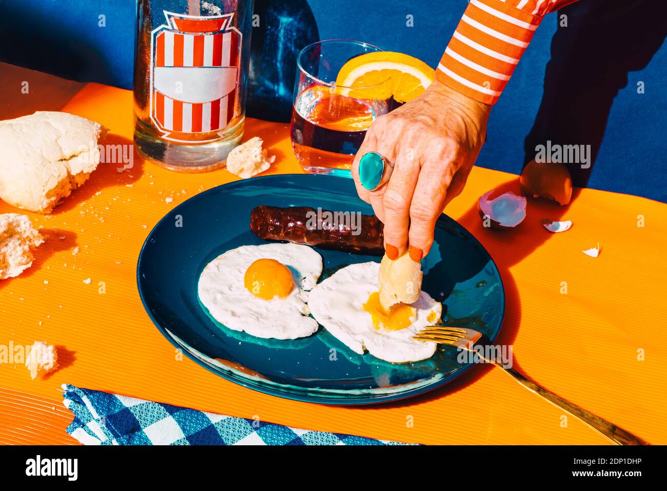 Arm of woman eating fried eggs with chorizo Stock Photo - Alamy