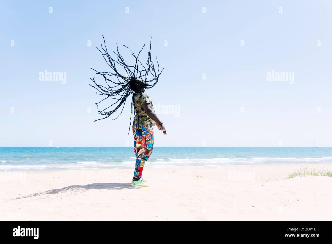 Rastafari man tossing his dreadlocks on the beach Stock Photo - Alamy