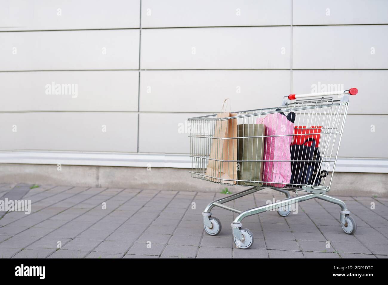 A Shopping Cart with paper bags staying on the road outdoor Stock Photo ...