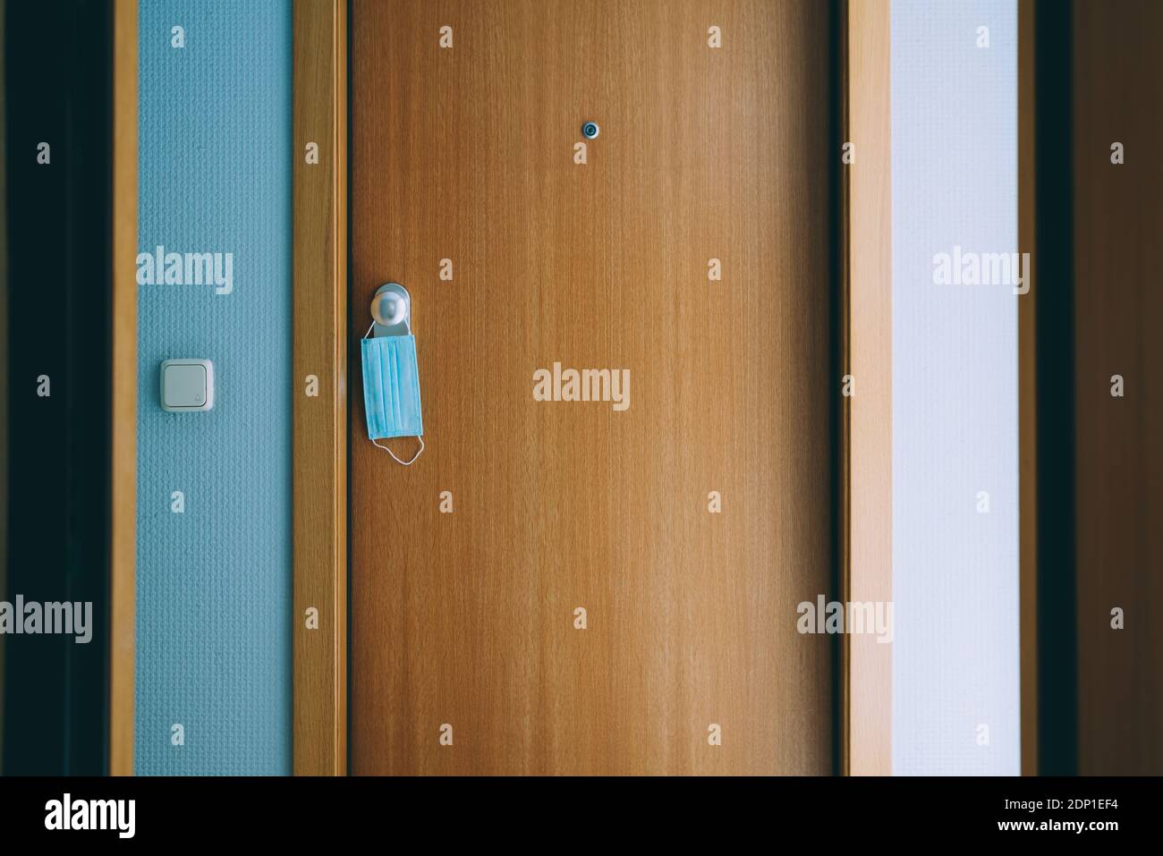 WOODEN DOOR WITH MASK HANGED ON THE LATCH IN A HOUSING PROTECTS YOU ...