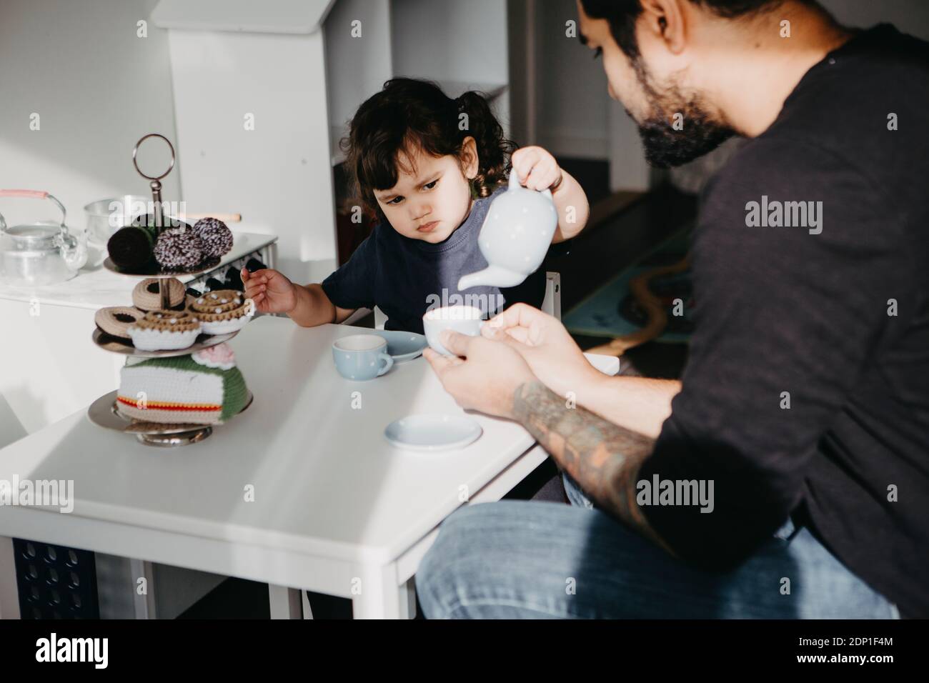 Father and daughter having tea party Stock Photo - Alamy
