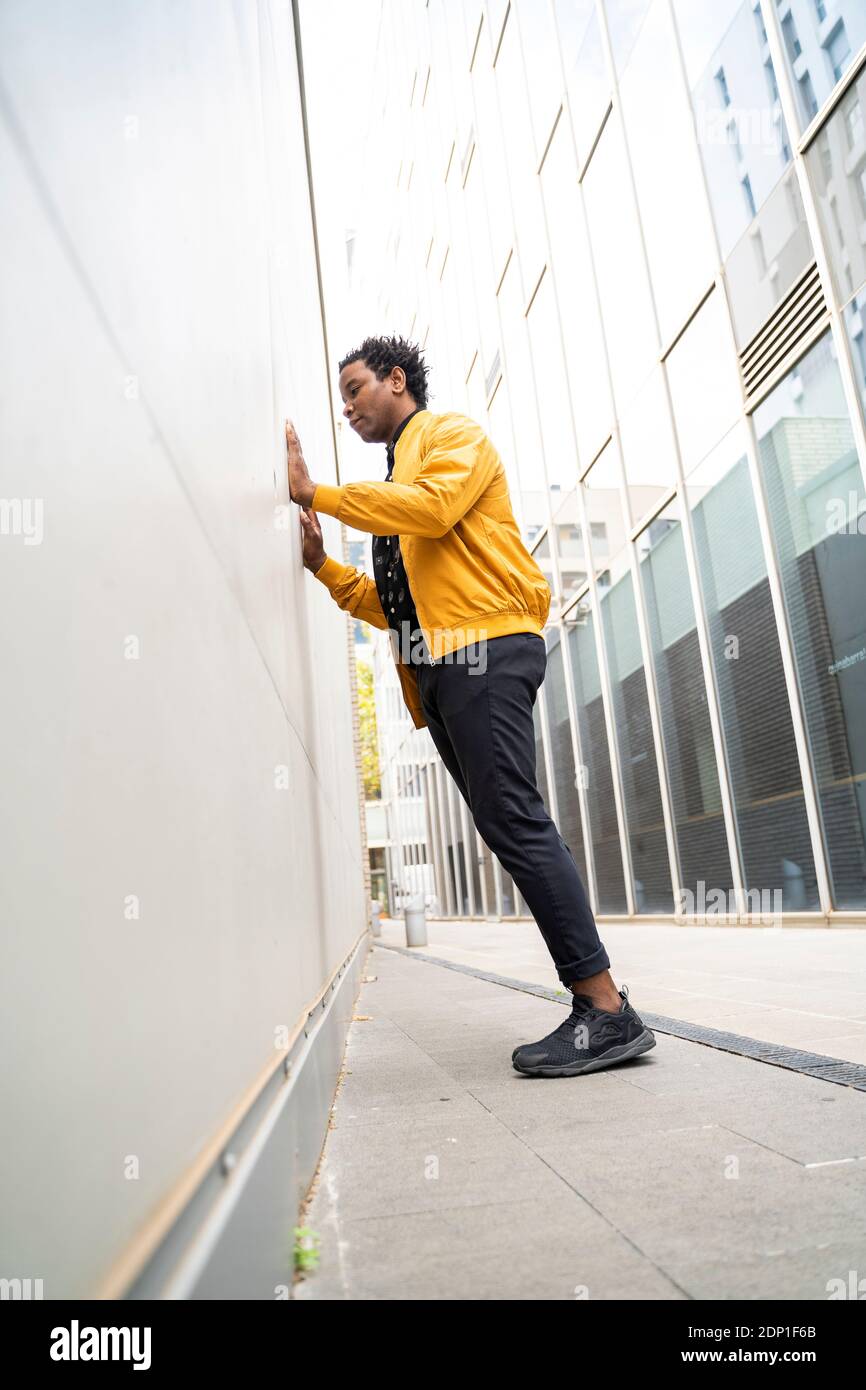 Man leaning on a wall Stock Photo - Alamy