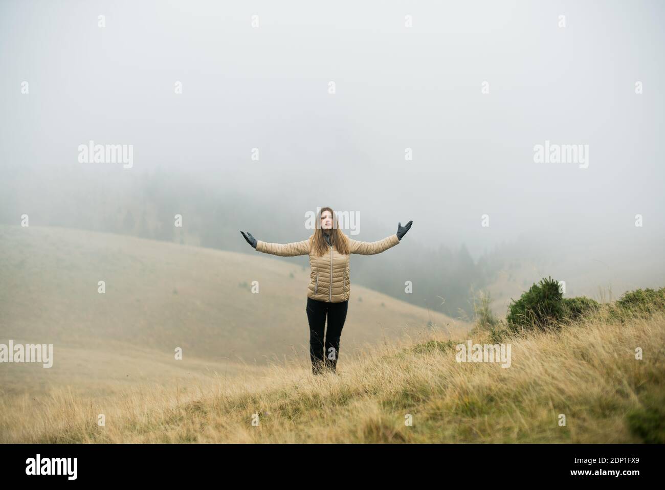 Beautiful Blonde Woman Holding Hands Up Stock Photo - Alamy