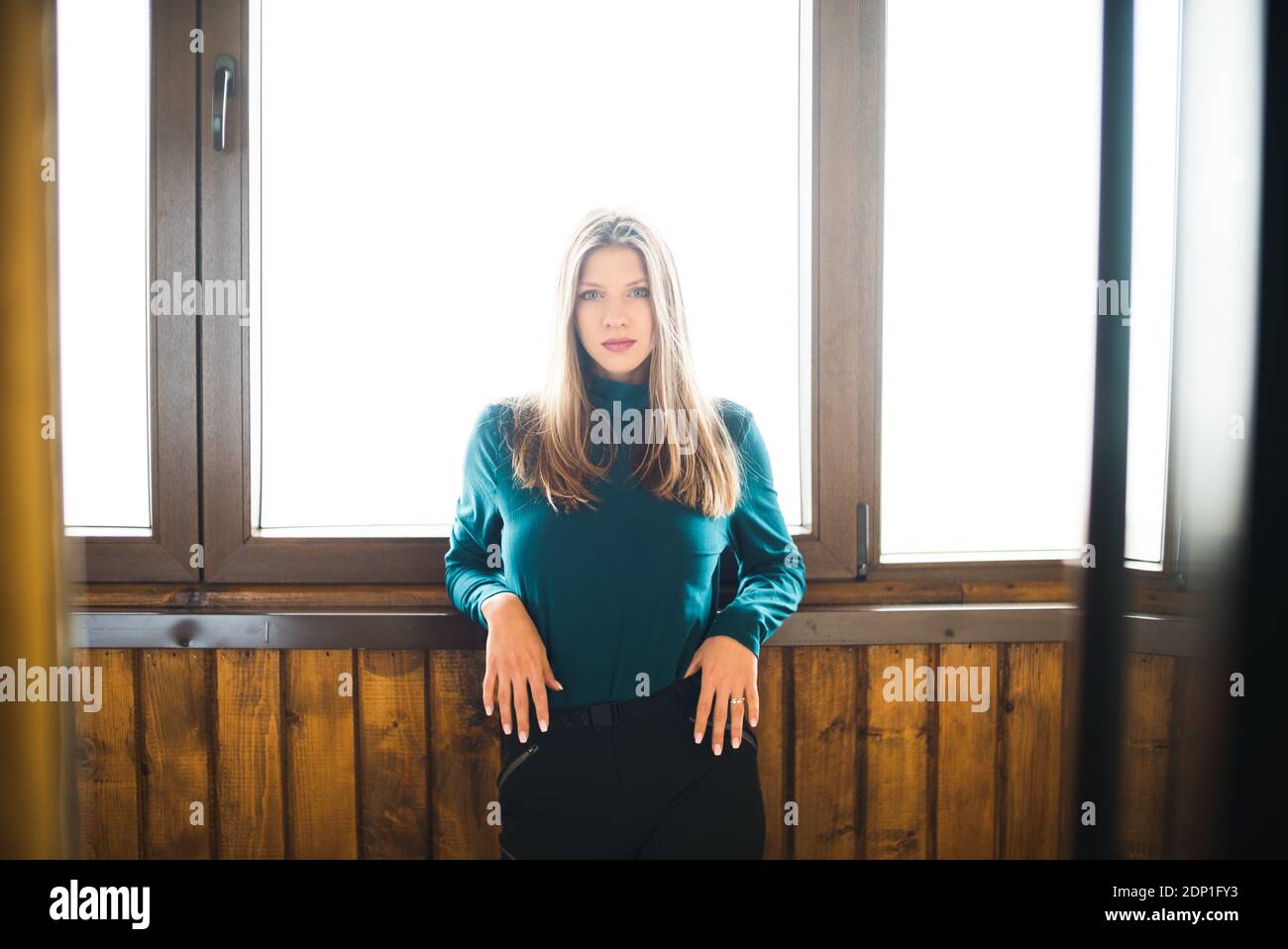 Beautiful Blonde Woman by the Window Stock Photo - Alamy
