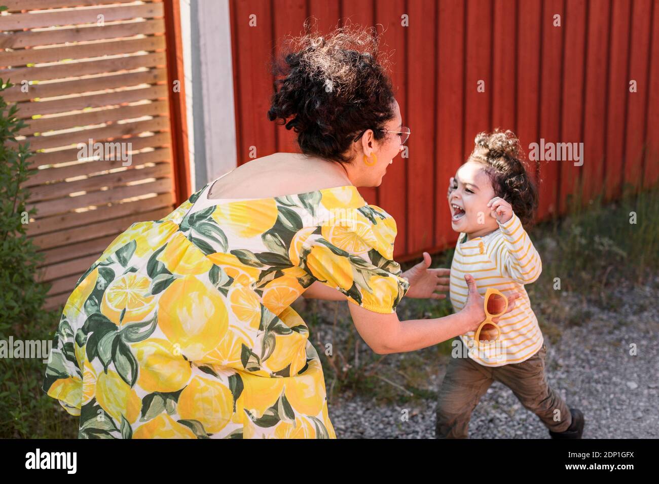 Happy toddler boy running into mothers arms Stock Photo - Alamy
