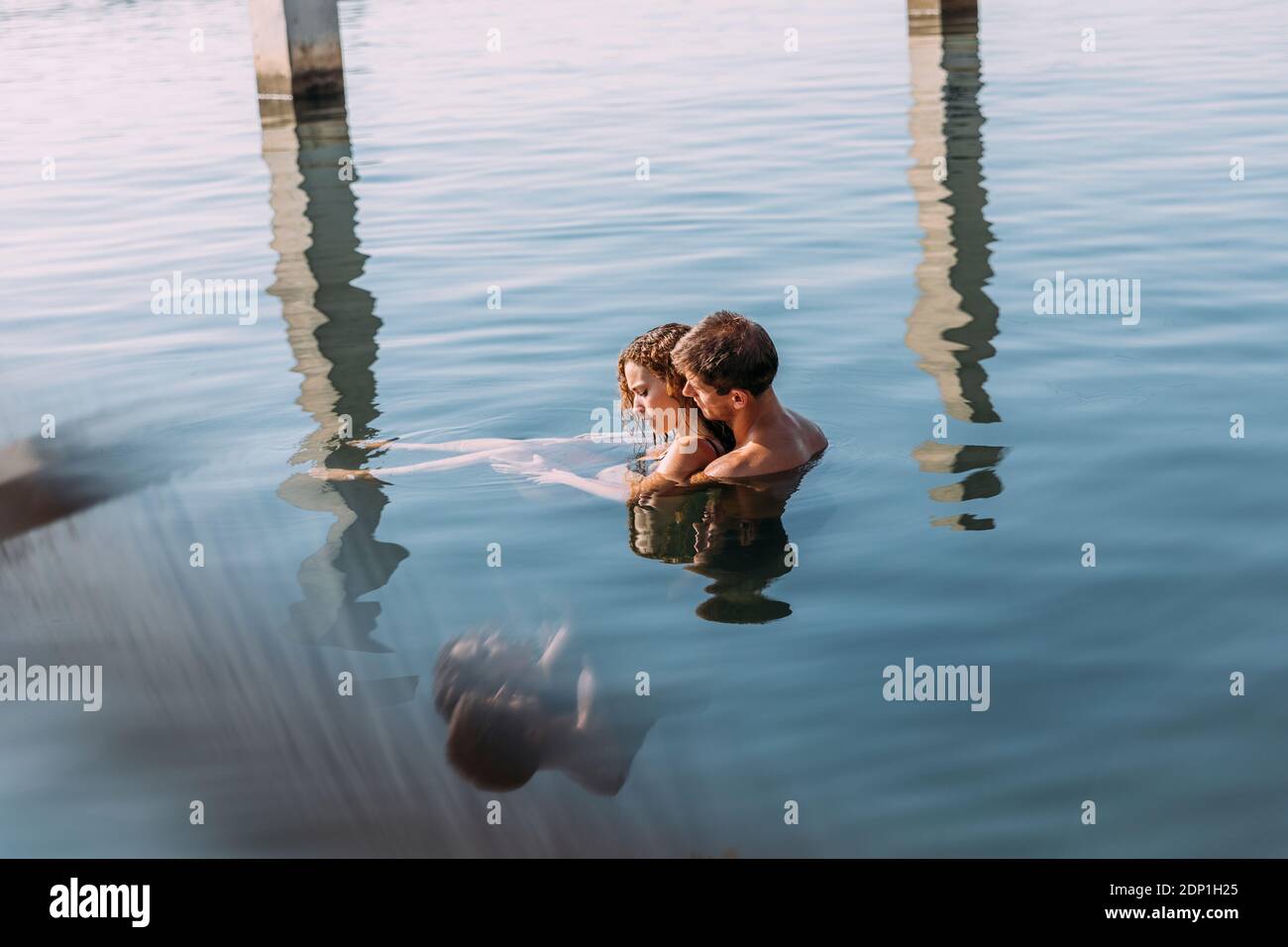 Affectionate young couple bathing in the sea Stock Photo - Alamy