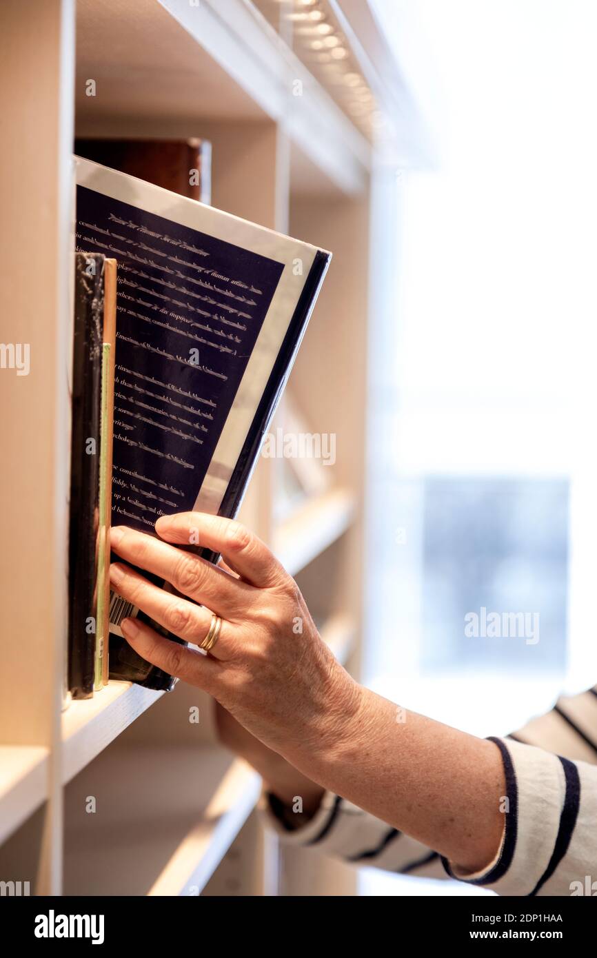 Taking book from shelf hi-res stock photography and images - Alamy