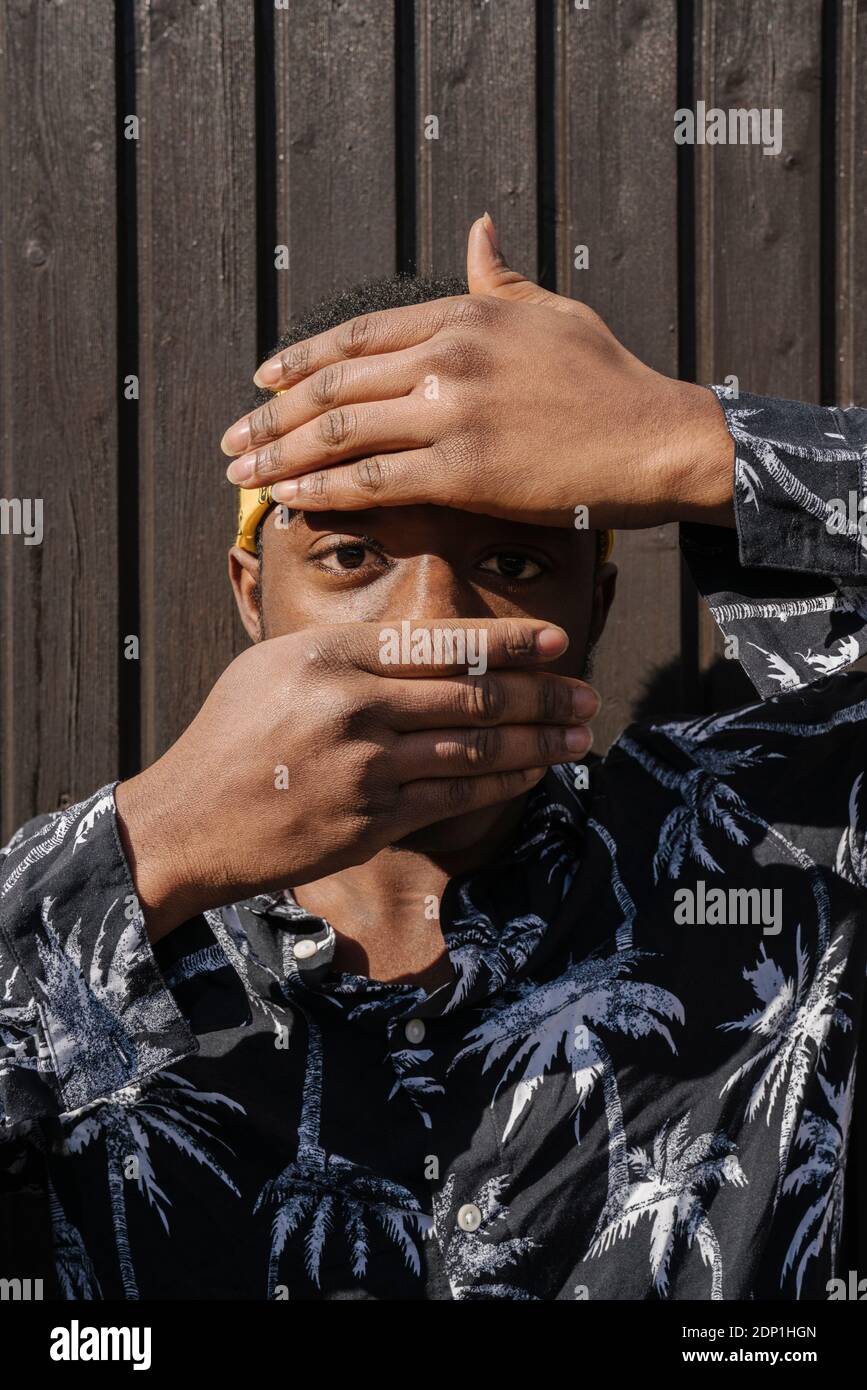 Portrait of man with hands on his face Stock Photo - Alamy