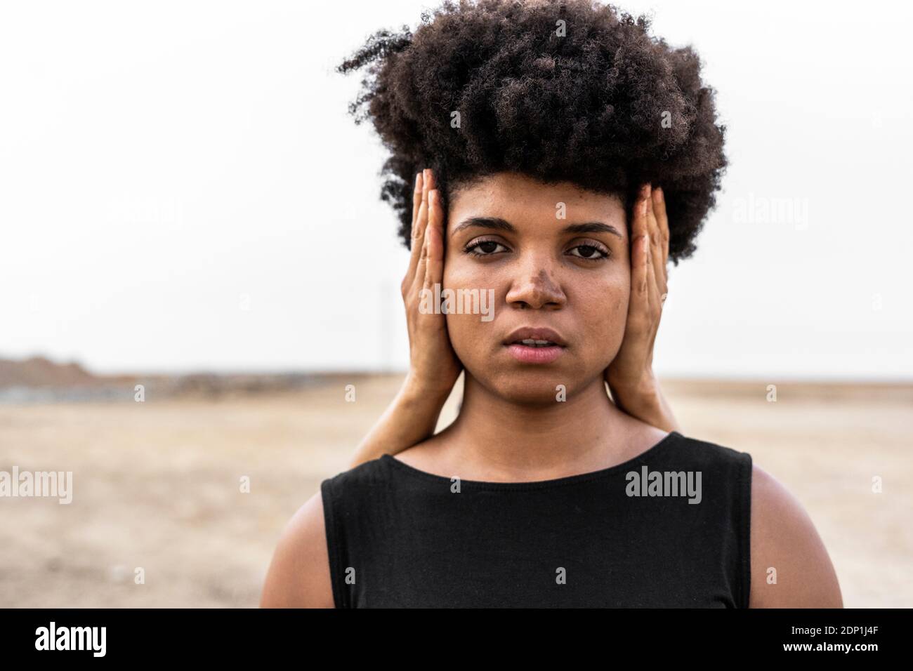 Hands covering woman's ears, close-up Stock Photo - Alamy