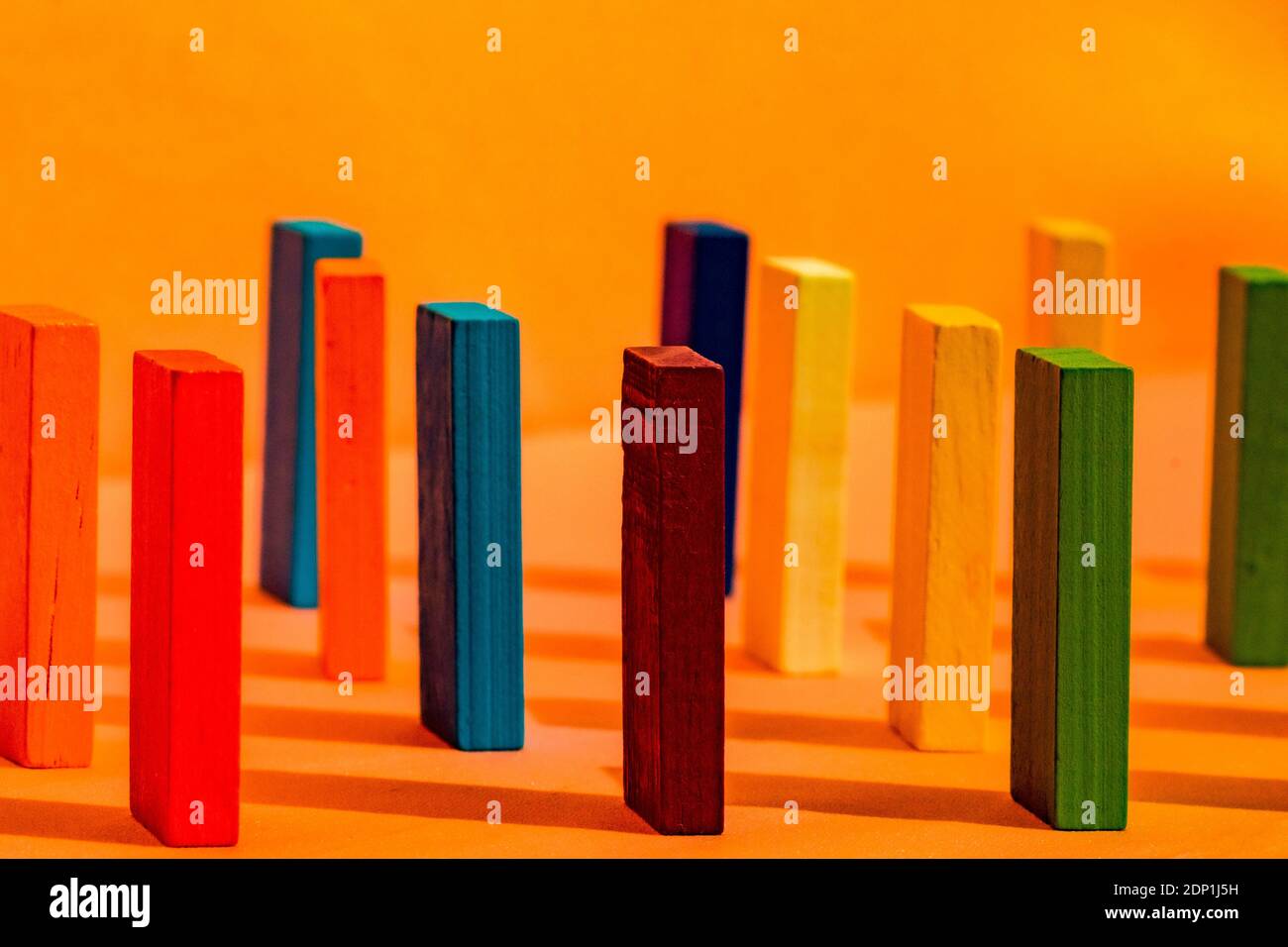 Colorful construction blocks on orange background Stock Photo - Alamy