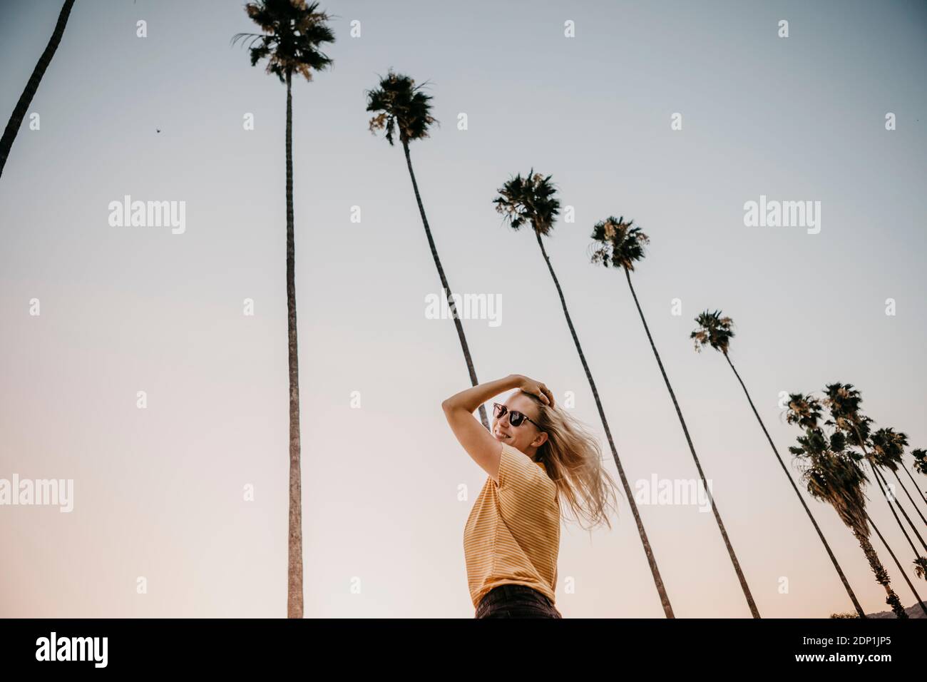 Women under the palm trees hi-res stock photography and images - Alamy