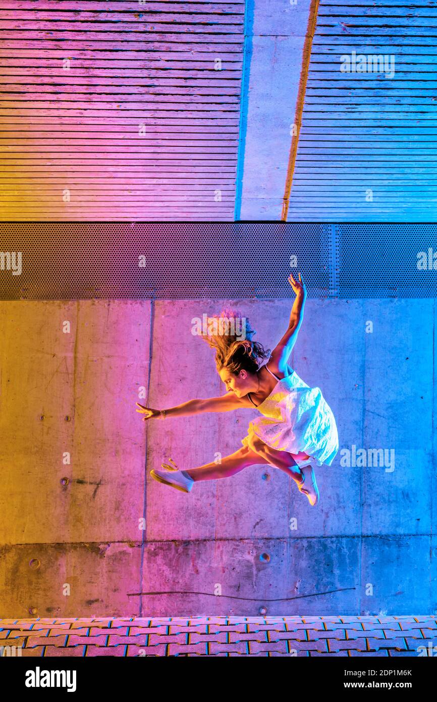 Acrobat dancing against wall Stock Photo - Alamy