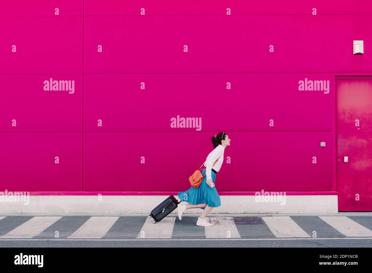 Woman running holding handbag hi-res stock photography and images - Alamy