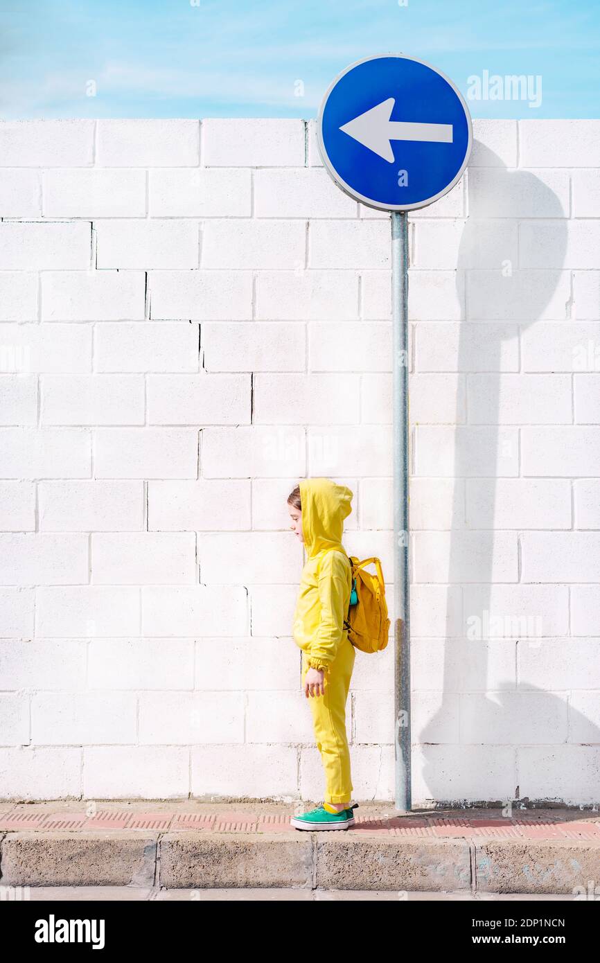Girl standing a traffic sign hi-res stock photography and images - Alamy
