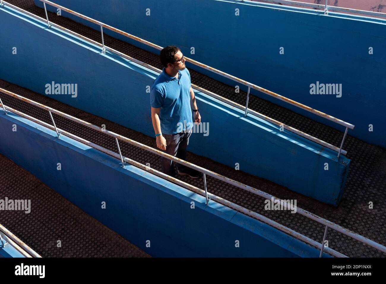 Mature man standing on a ramp looking at distance Stock Photo - Alamy