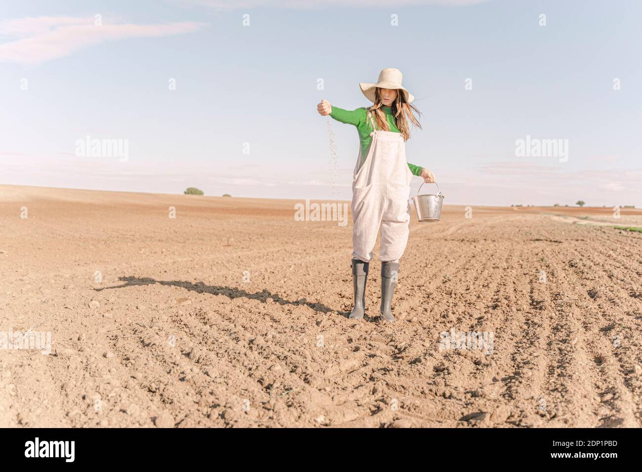 Young woman sowing field for the future Stock Photo - Alamy