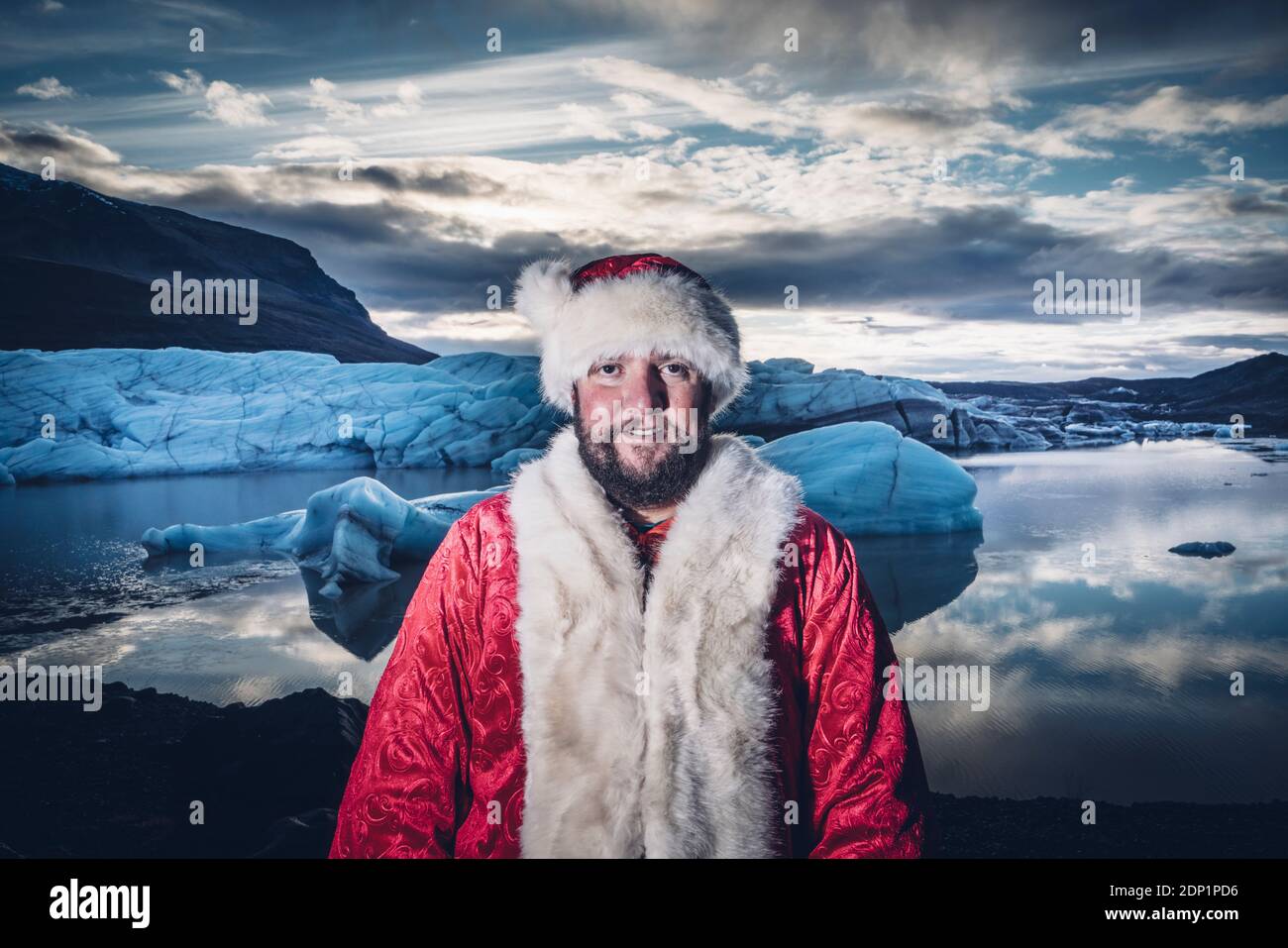 Iceland, portrait of a smiling man disguised as Santa Claus standing at ...