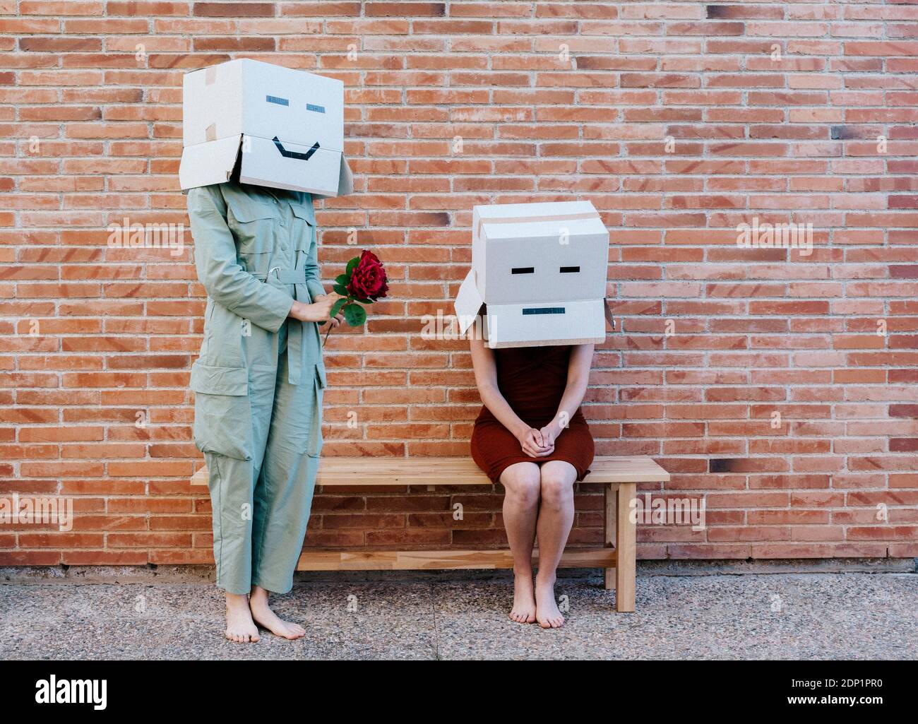 bench in front of brick wall with face on cardboard box Stock Photo - Alamy