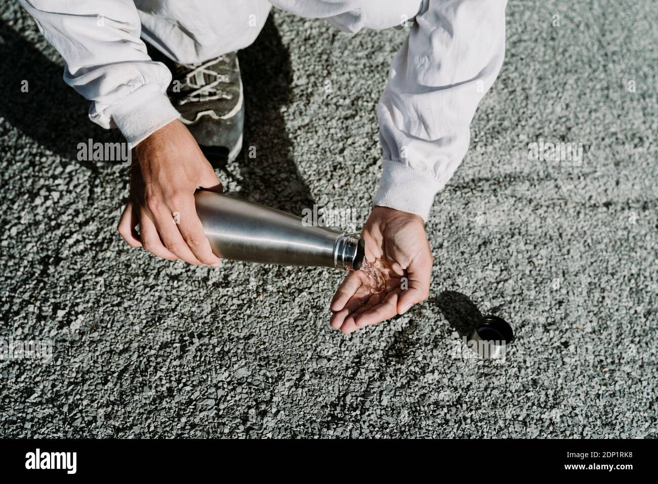 Hand pouring water from bottle hi-res stock photography and images - Alamy
